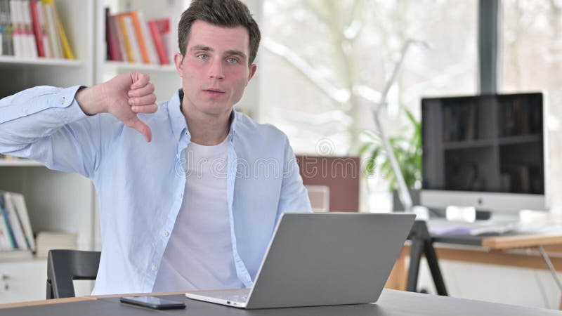 Thumbs Down by Young Man Working on Laptop Stock Image - Image of ...