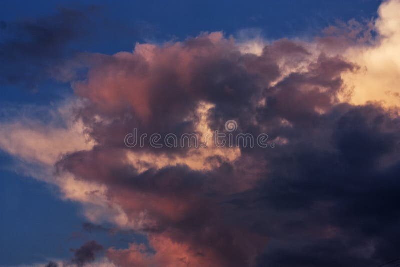 A Dark Big Cloud and Small Curly Clouds. Stock Image - Image of ...