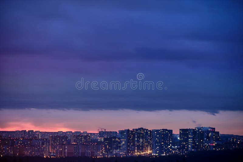 Thunderclouds Over a Dark City at Night with High-rise Buildings ...