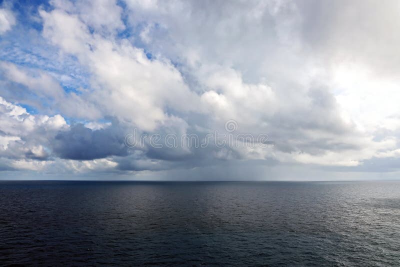 Thunderclouds and Rain Clouds Over the Sea Horizon and the Surface of ...