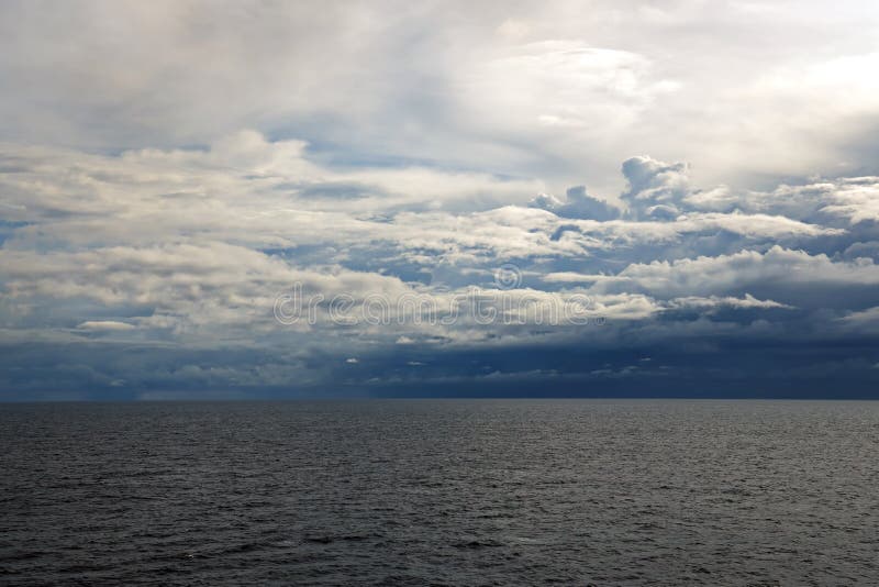 Thunderclouds and Rain Clouds Over the Sea Horizon and the Surface of ...