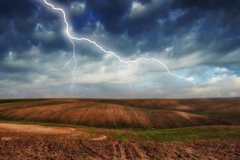 Thunderstorm in the Field. Huge Lightning Over a Hilly Field Stock ...