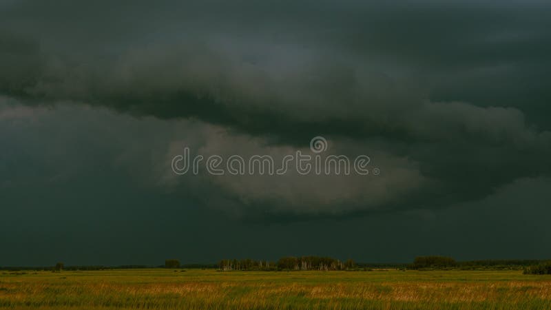 Thunderstorm in the Field. Huge Lightning Over a Hilly Field Stock ...
