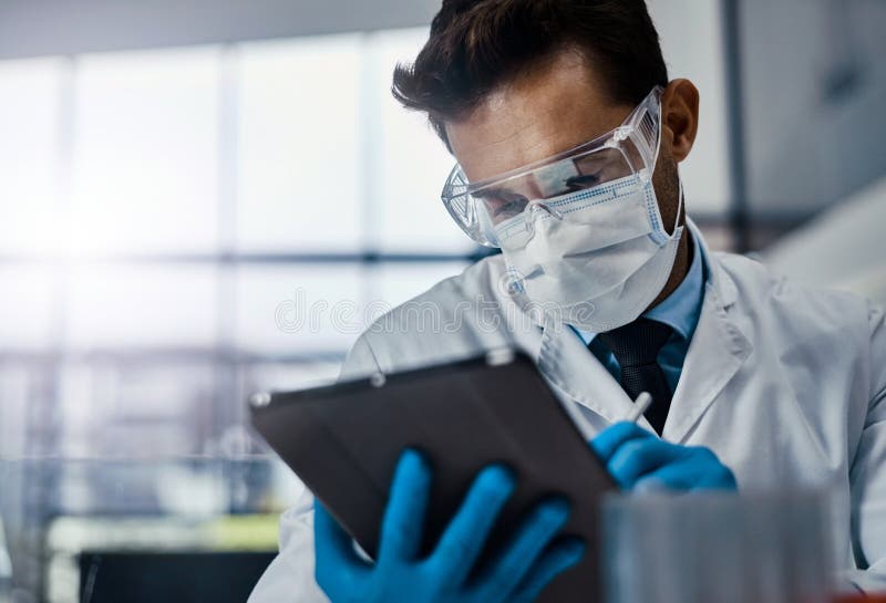 Ticking Off My Checklist. a Young Male Scientist Working in a Lab ...