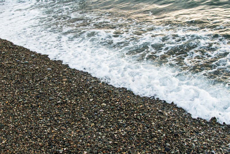 The Wave Rolls Onto the Seashore, Which is Covered with Small Stones ...