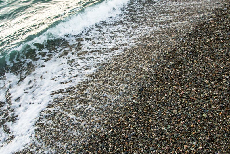 The Wave Rolls Onto the Seashore, Which is Covered with Small Stones ...