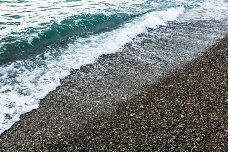 The Wave Rolls Onto the Seashore, Which is Covered with Small Stones ...
