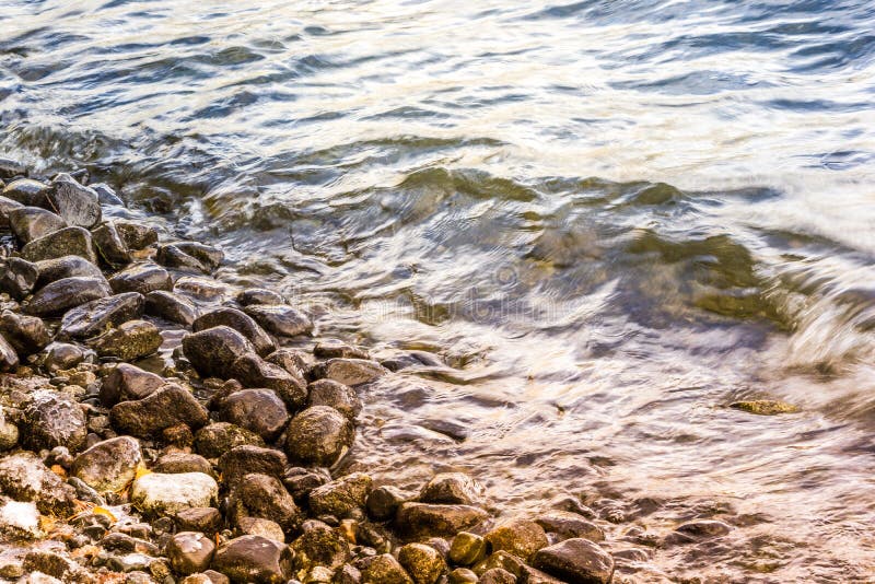 A tidal wave on the beach stock photo. Image of shore - 115304940