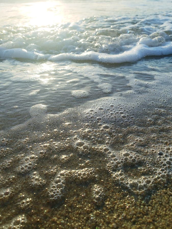 Tide Rolling Onto the Shore with Horizon Under Cloud Shadow and Kite ...