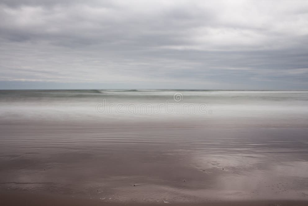 Tide rolling in softly stock photo. Image of clouds, blur - 57154592