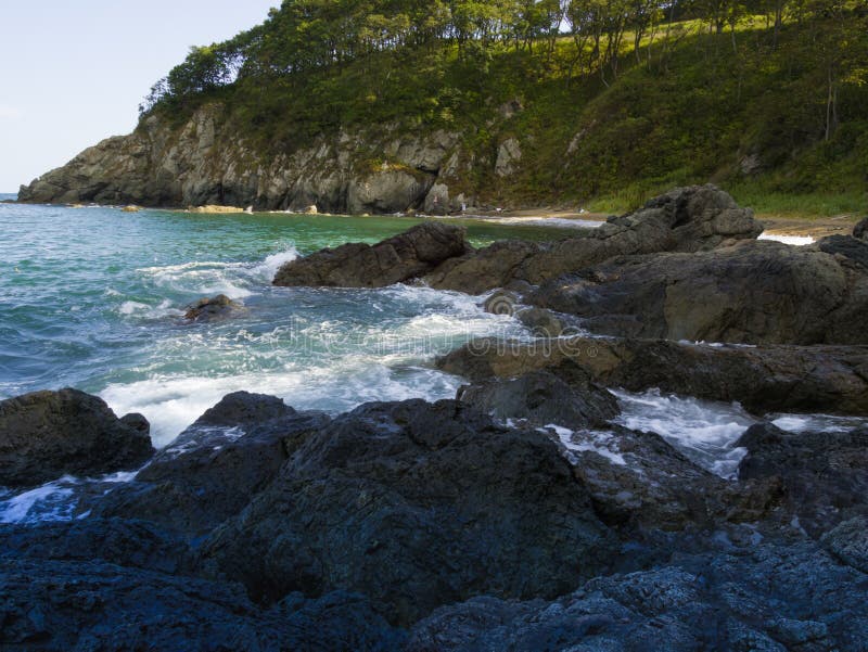 Tide wave on rocky shore. stock image. Image of bubble - 227858351