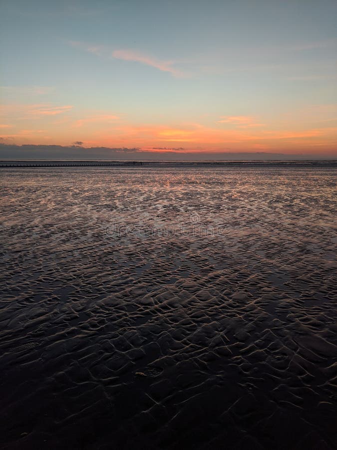 Tides out sunsetting stock image. Image of tides, sunsetting - 171962139