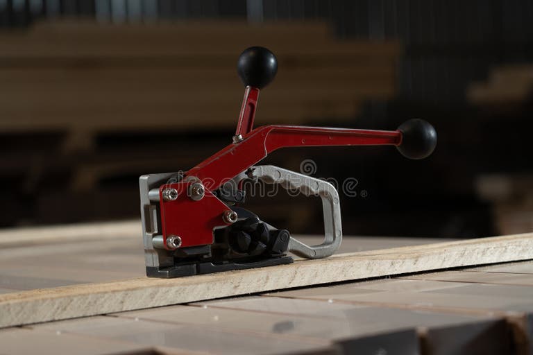 Strapping, a Tool for Strapping Pallets, Lies on a Stack of Wooden ...