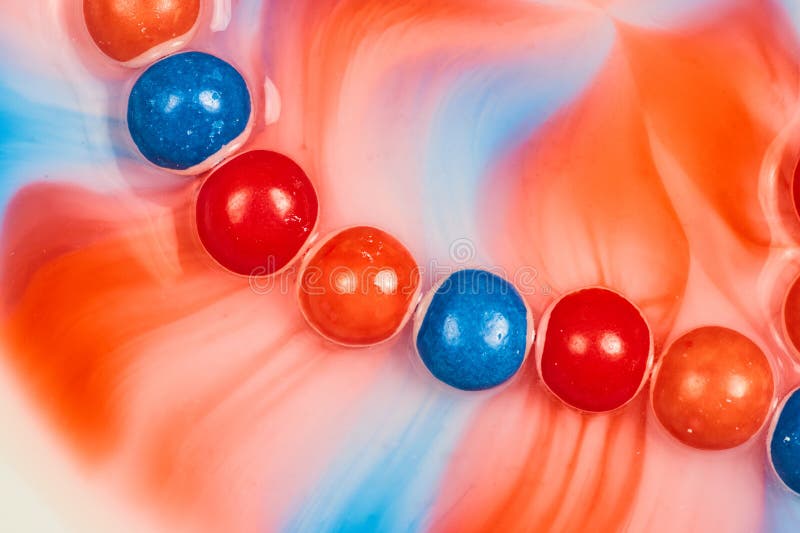 Tie Dye Effect from Orange and Red and Blue Skittles in Water Stock ...