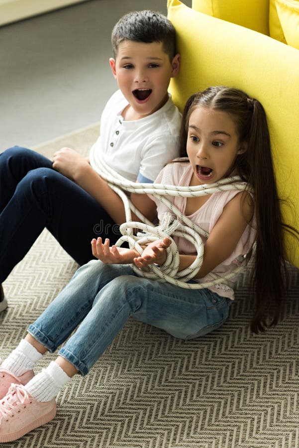 Tied With Rope Sister And Brother Sitting On Floor And Screaming Stock Image Image Of