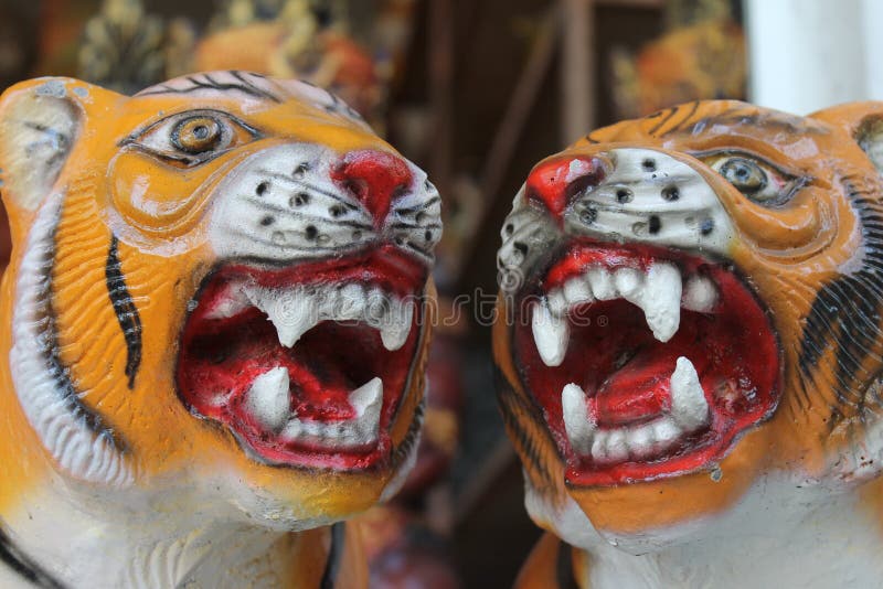 2 Tiger Statues with Orange Color and Sharp Teeth Stock Image - Image ...