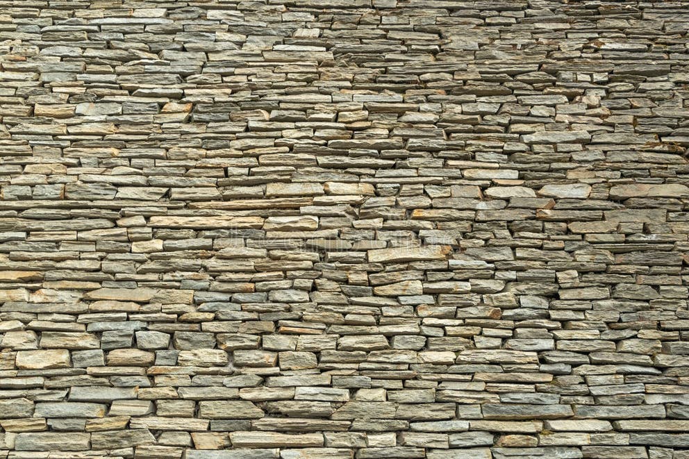 A Tightly Stacked Stone Wall with Irregular, Layered Rocks, Creating a ...