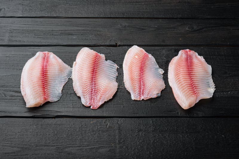 Tilapia Fish Fillet Meat, on Black Wooden Table, Top View Stock Image ...