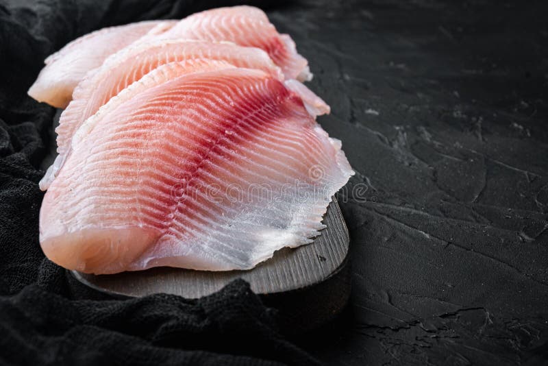 Tilapia Fish Skinless Meat, on Black Background Stock Image - Image of ...
