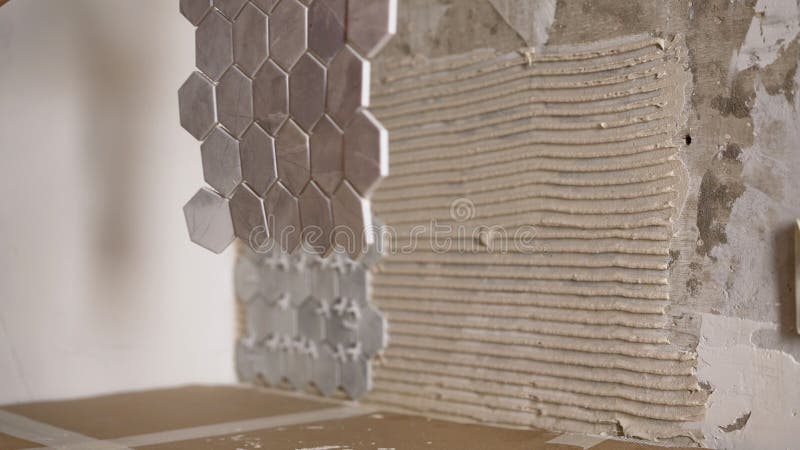 The Tile is Applying Adhesive To the Kitchen Wall. the Process of ...