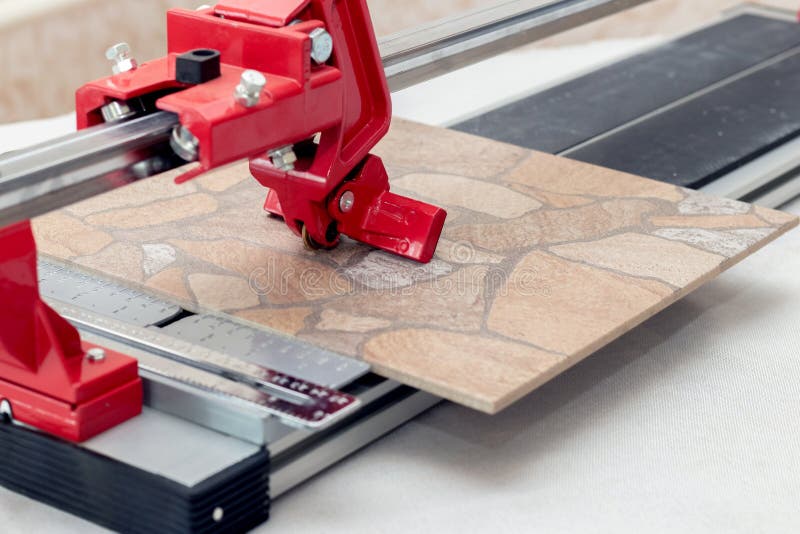 Tile Cutter and Ceramic Tile at the Master`s Workplace Stock Photo ...