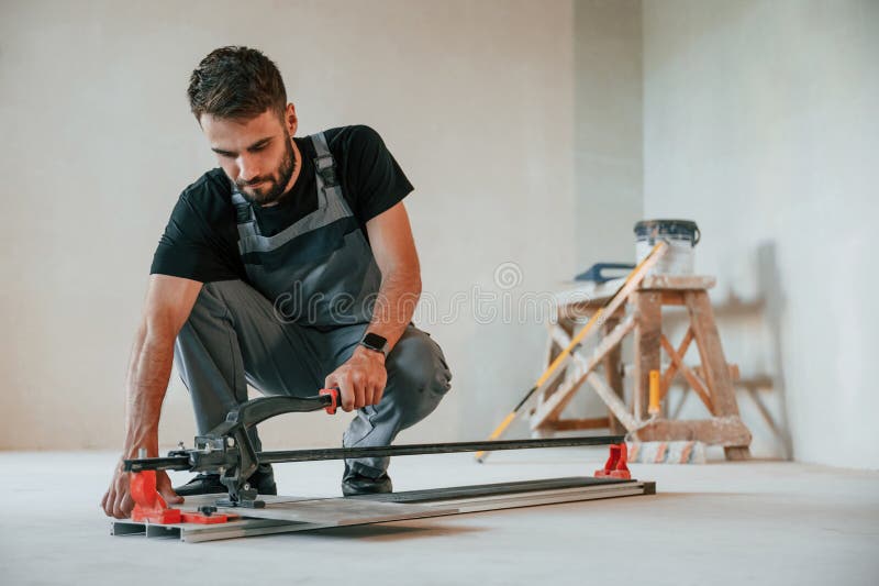 Tile Cutting Process. the Man is Making Repairs in the Apartment Stock ...