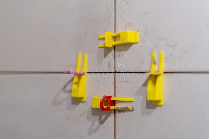 Tile Leveling System with Plastic Clips and Wedges in Action. Ensures ...