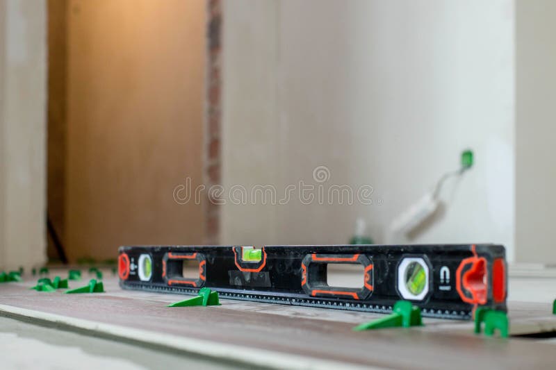 Tile Levelling System, Four Plastic Green Clips with Wedges. Close-up ...