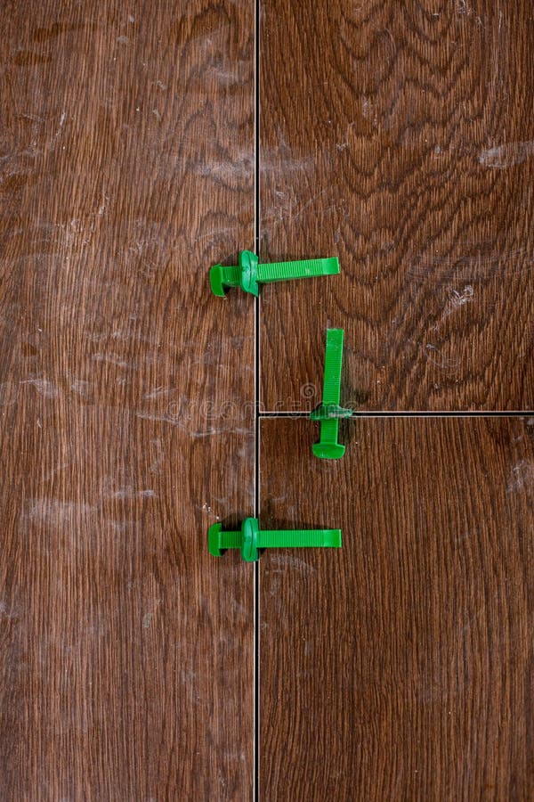 Tile Levelling System, Four Plastic Green Clips with Wedges. Close-up ...