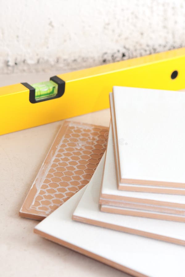 Tile and tool level stock image. Image of construction - 14990209