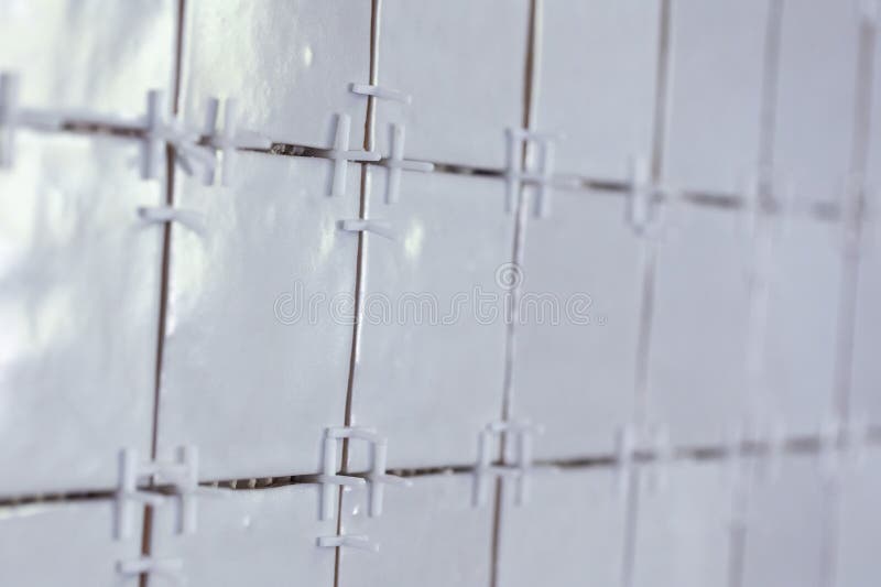 A Tile Wall Under Construction. the Wall is Being Tiled with Small ...