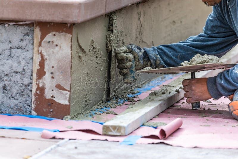 Tile Worker Applying Cement with Trowel at Pool Construction Site Stock ...
