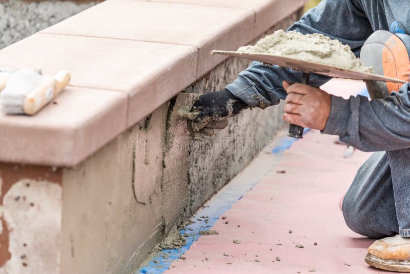 Tile Worker Applying Cement with Trowel at Pool Construction Site Stock ...