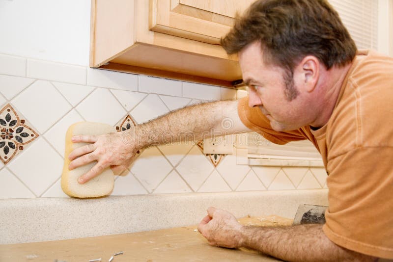 Tile Worker Wipes Grout stock image. Image of builder - 8455025