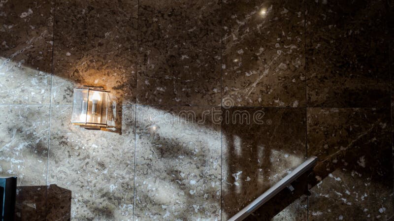 Tiled Marble Wall Which a Lit Wall Light Hangs Stock Photo - Image of ...