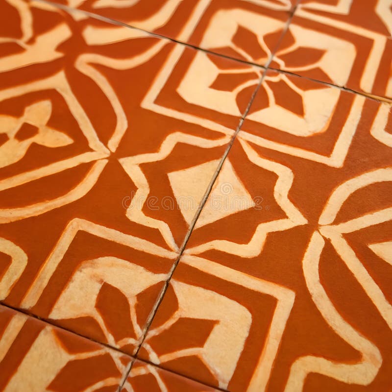 Tiled Surface with a Repeating Geometric Floral Pattern in Terracotta ...