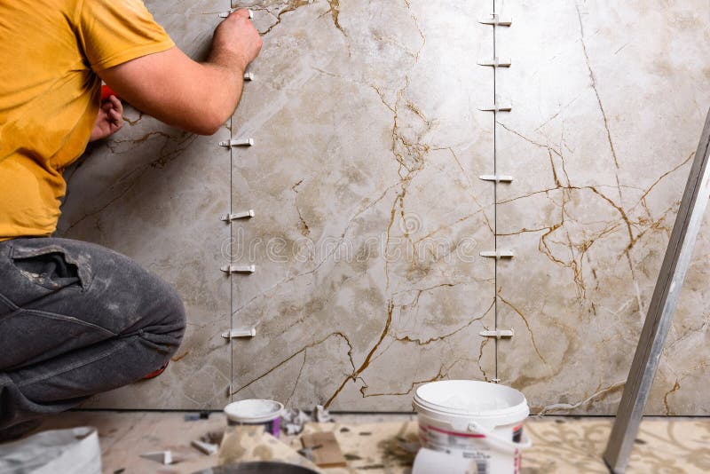 Tiler Installing Leveling System Tiles on Wall. Stock Photo - Image of ...