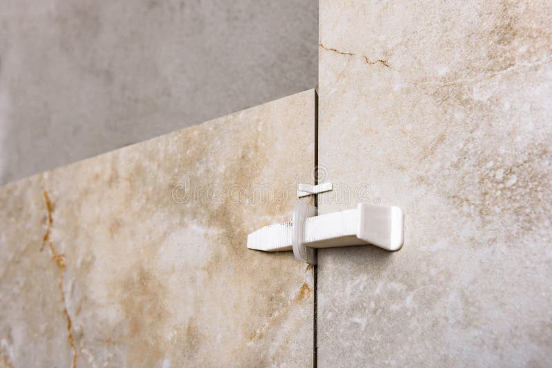 Tiler Installing Leveling System Tiles on Wall. Stock Photo - Image of ...