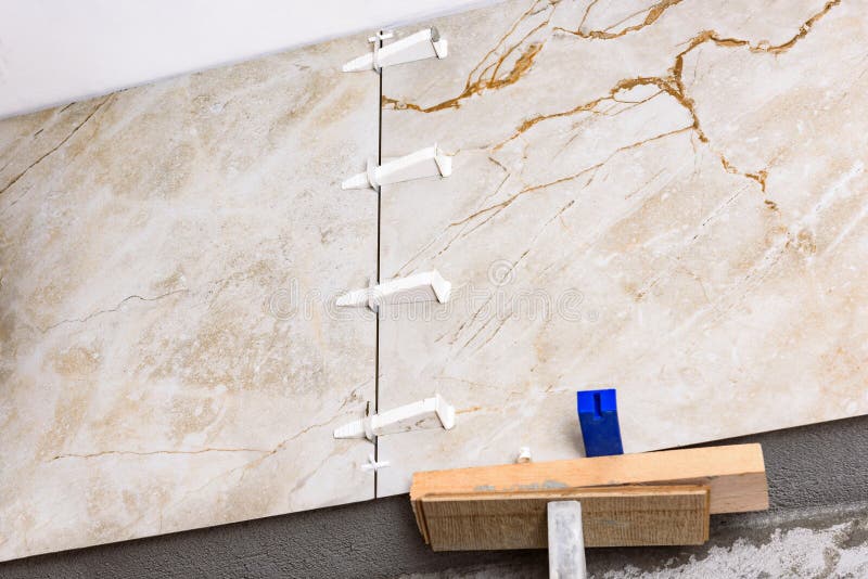 Tiler Installing Leveling System Tiles on Wall. Stock Image - Image of ...