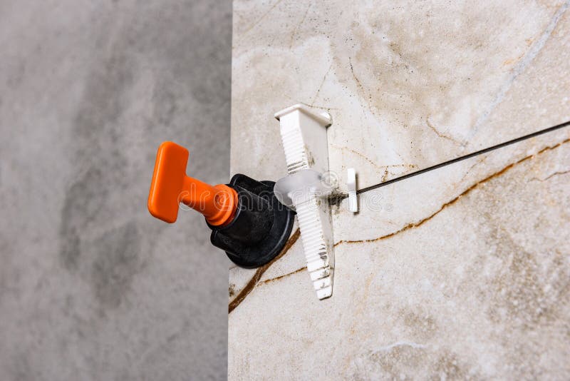 Tiler Installing Leveling System Tiles on Wall. Stock Photo - Image of ...