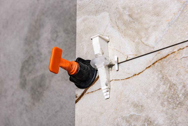 Tiler Installing Leveling System Tiles on Wall. Stock Photo - Image of ...