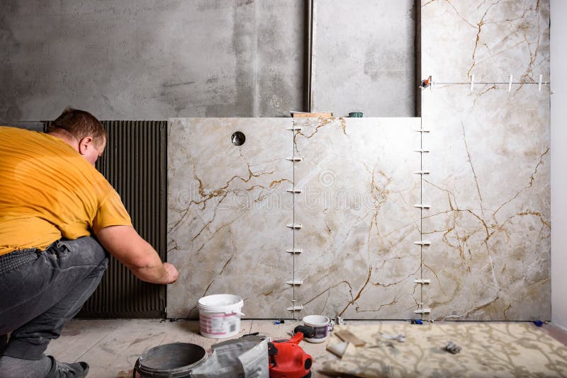 Tiler Installing Leveling System Tiles on Wall. Stock Photo - Image of ...
