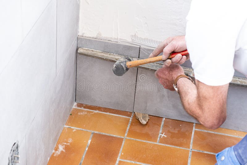The Tiler Lays a Ceramic Tile on the Wall Stock Photo - Image of ...