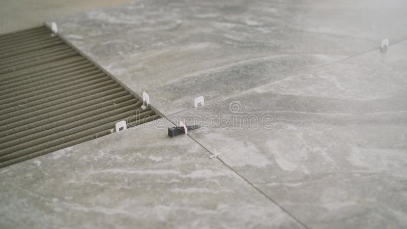 Tiler Placing Leveling Wedges for Tiles Installation Stock Footage ...