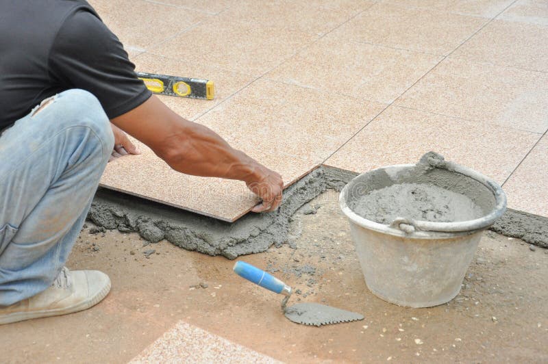 Tiler Placing Tile in Position Over Mixed Mortar for Tile Stock Image ...