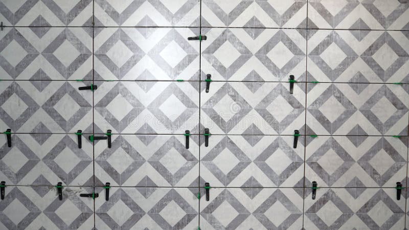 Tiler Placing Tiles on Wall with Leveling System Stock Photo - Image of ...