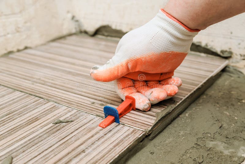 Tiler`s Hand is Aligning Tiles. Stock Image - Image of hand, tools ...