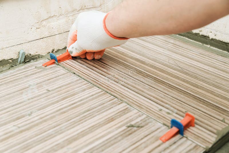 Tiler`s Hand is Aligning Tiles. Stock Image - Image of glue, tools ...