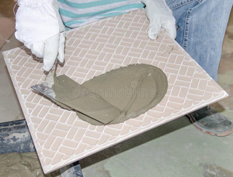 Tiler Spreading Tile Adhesive on the Back of a Tile Stock Image - Image ...