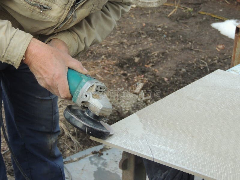 A Tiler Uses a Grinder To Remove a Layer on the Back Side of a Facing ...